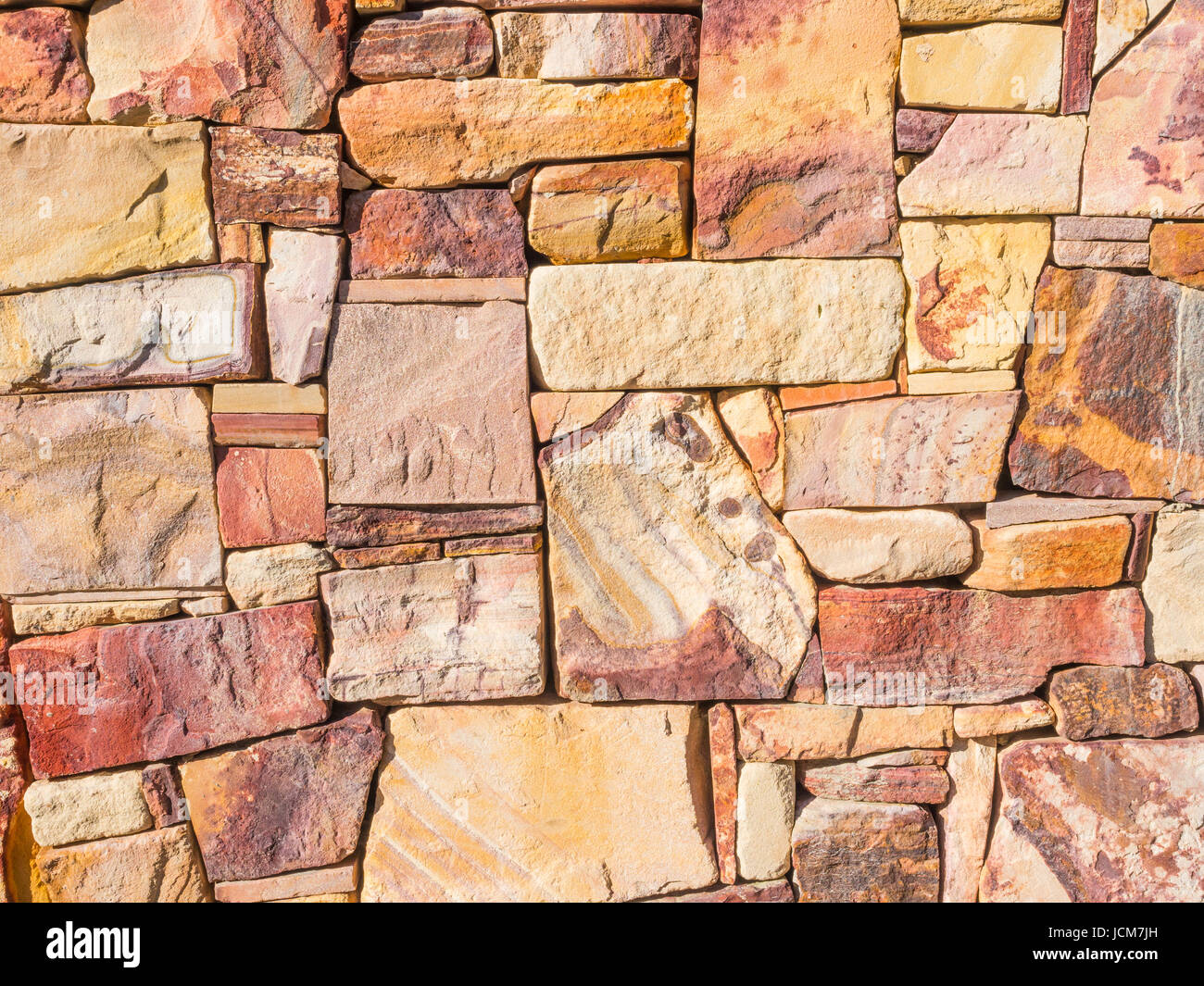 A rock wall background made from colorful Australian rocks Stock Photo ...