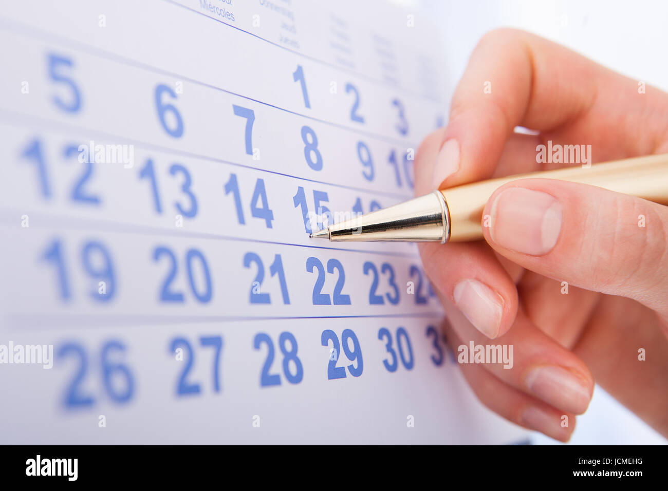 Closeup of woman's hand marking date 15 on calendar Stock Photo - Alamy