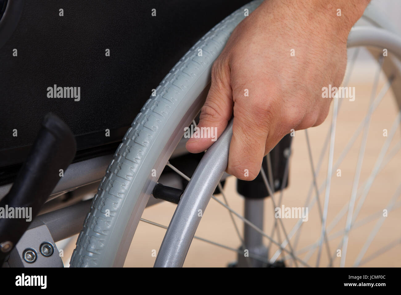 Closeup of handicapped man's hand pushing wheel of wheelchair Stock ...