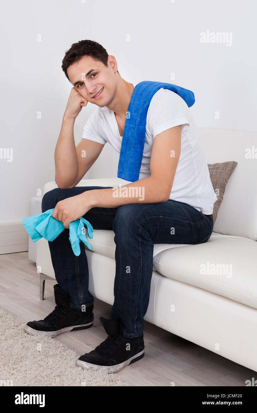 Full length portrait of young man with napkin and gloves at home Stock ...