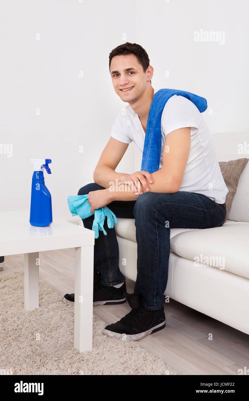 Full length portrait of young man with napkin and gloves at home Stock ...