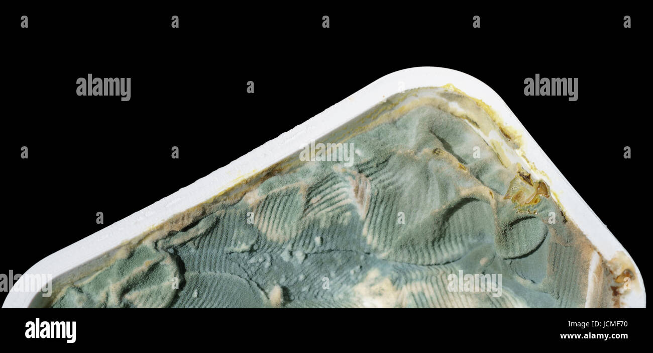 Rotten fresh cheese or butter on tub and black background Stock Photo ...