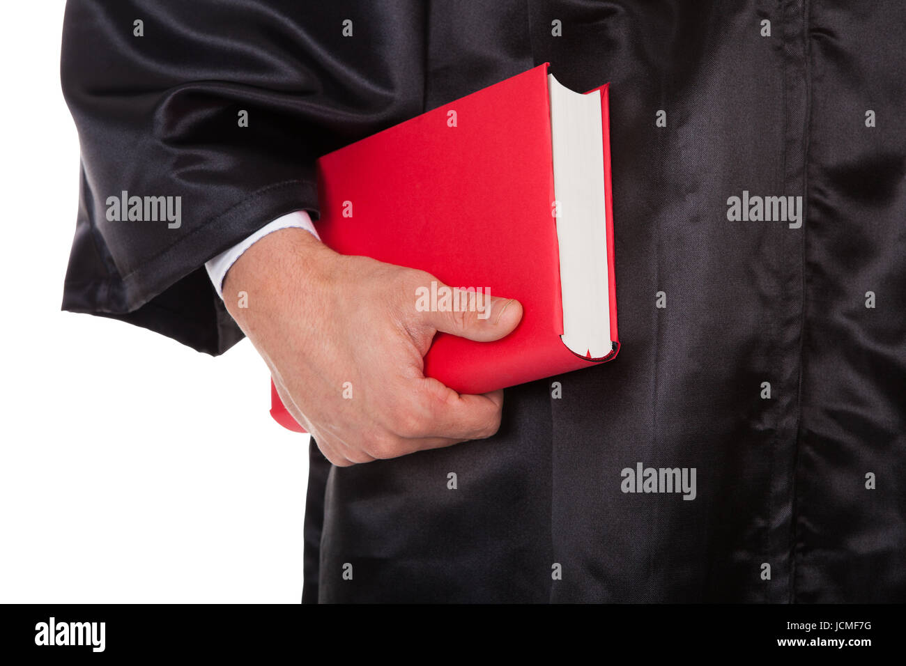 Midsection of male judge holding statute book against white background ...