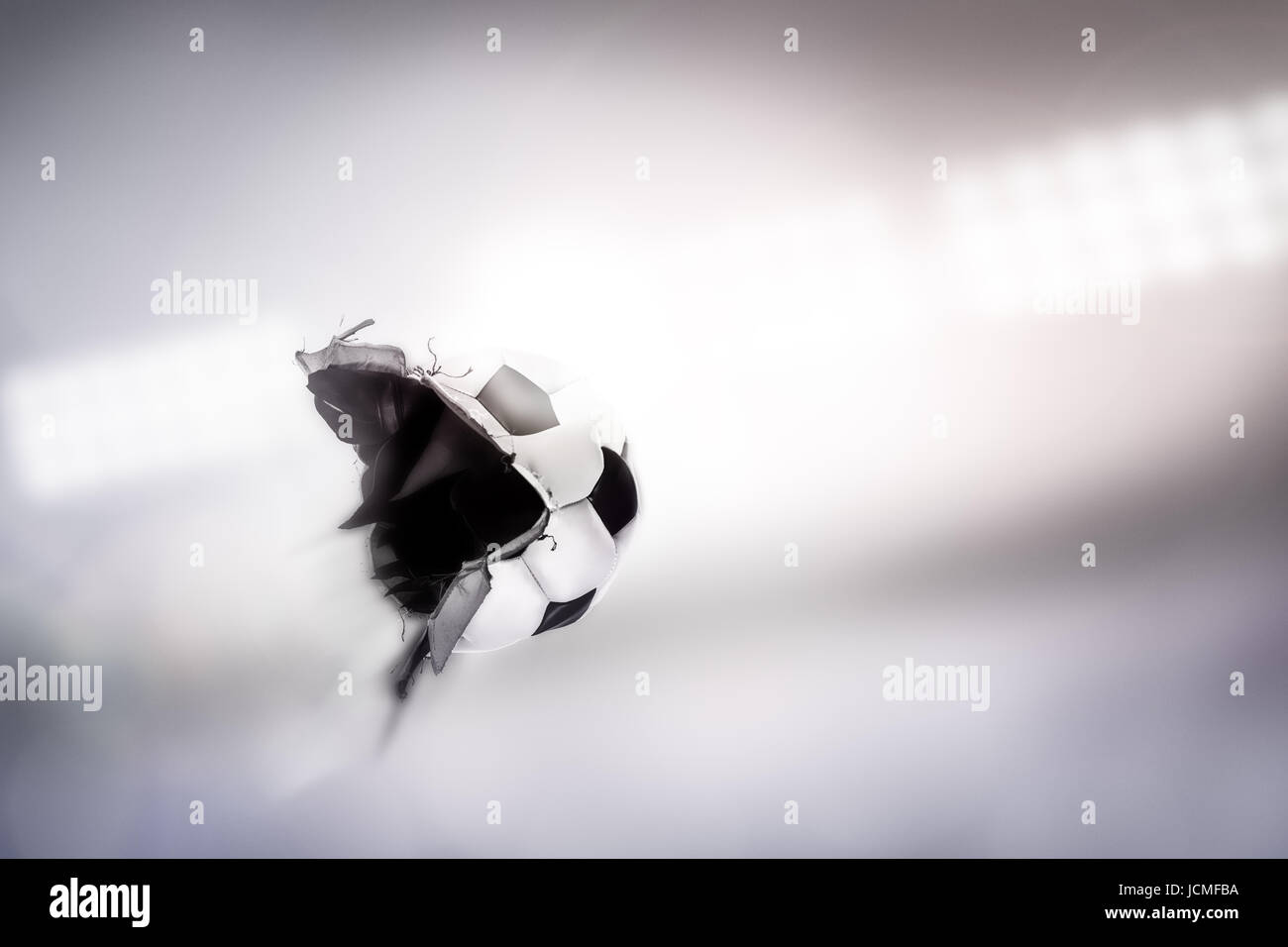 traditional football flying through the air after being hit so hard it ...