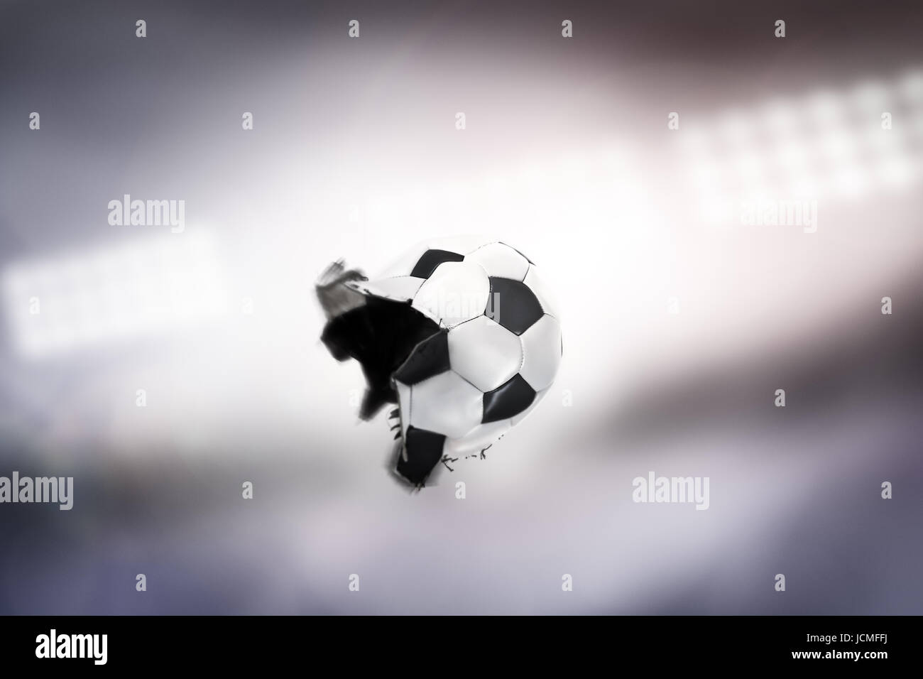 traditional football flying through the air after being hit so hard it ...