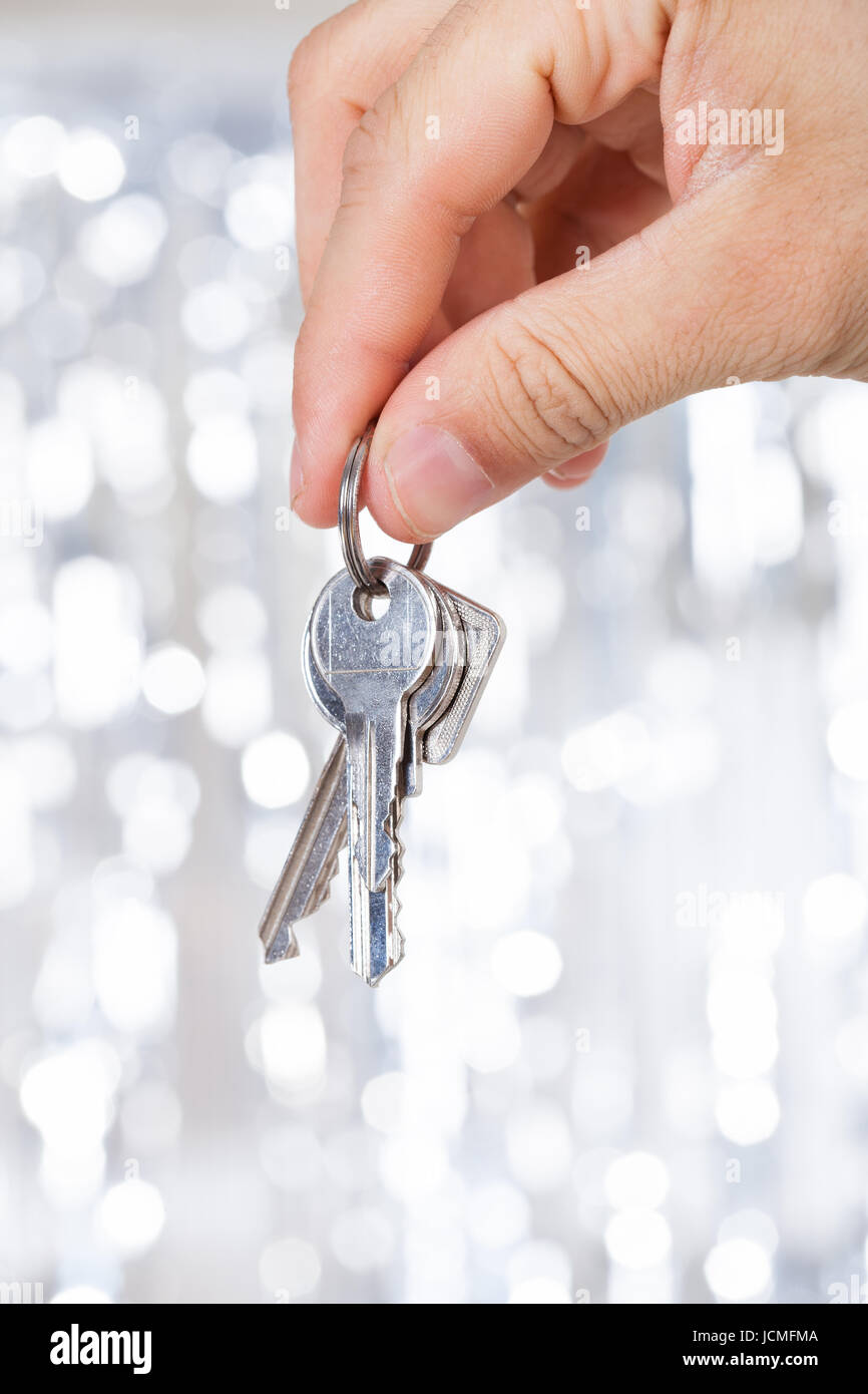 Cropped image of man holding keys indoors Stock Photo - Alamy