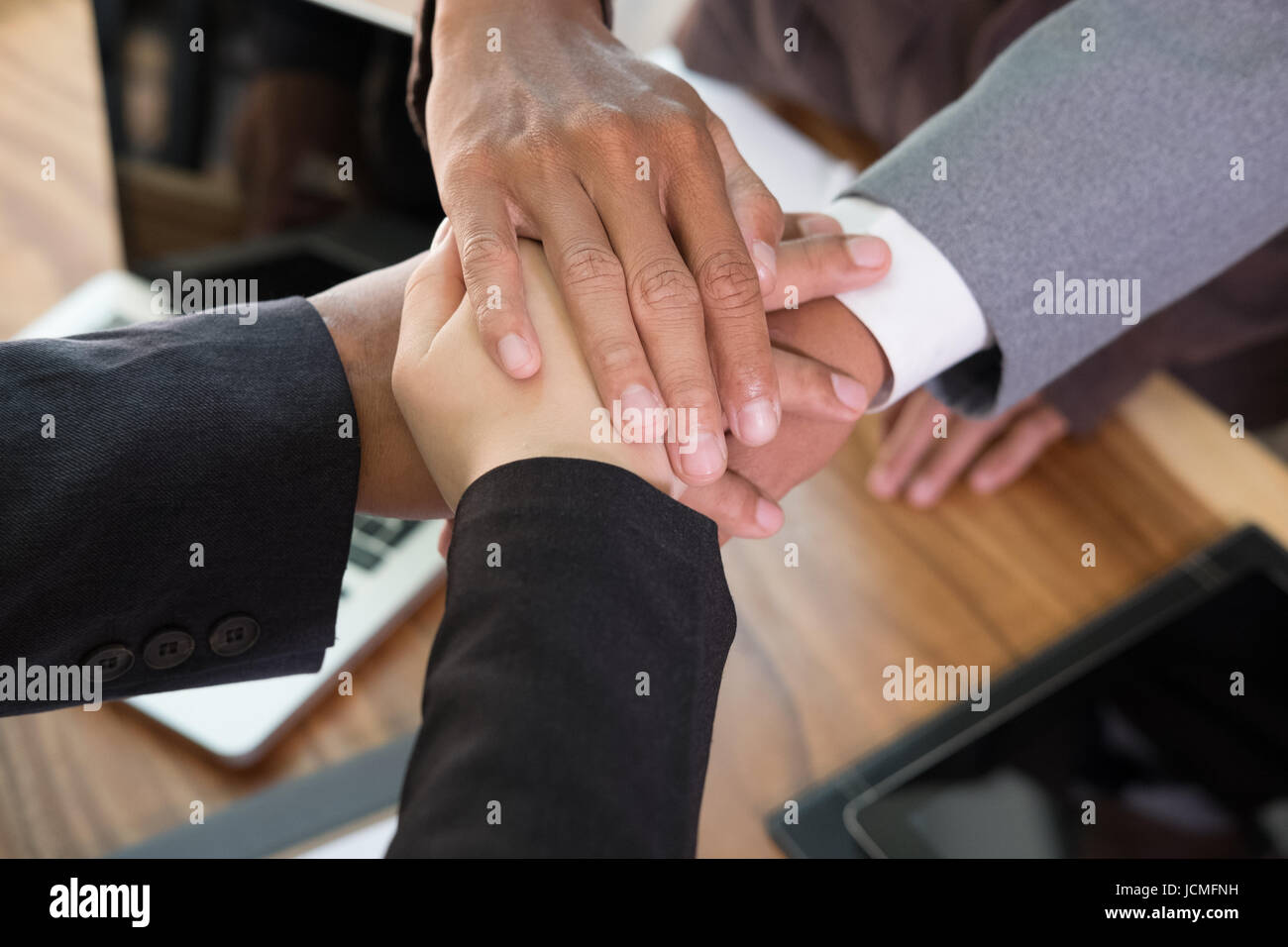 young asian businessman joining united hand, business team touching ...