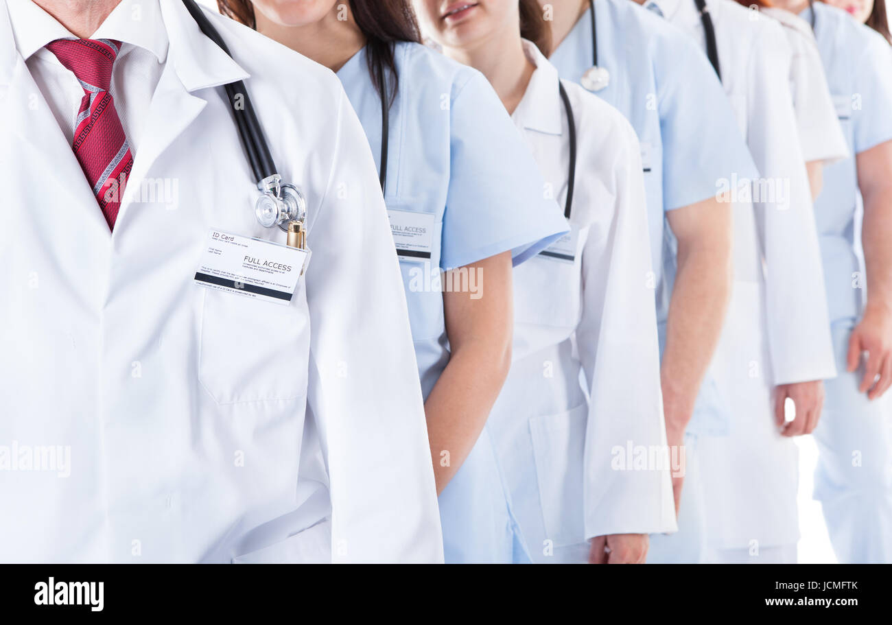 Long receding line or queue of smiling doctors and nurses in white ...