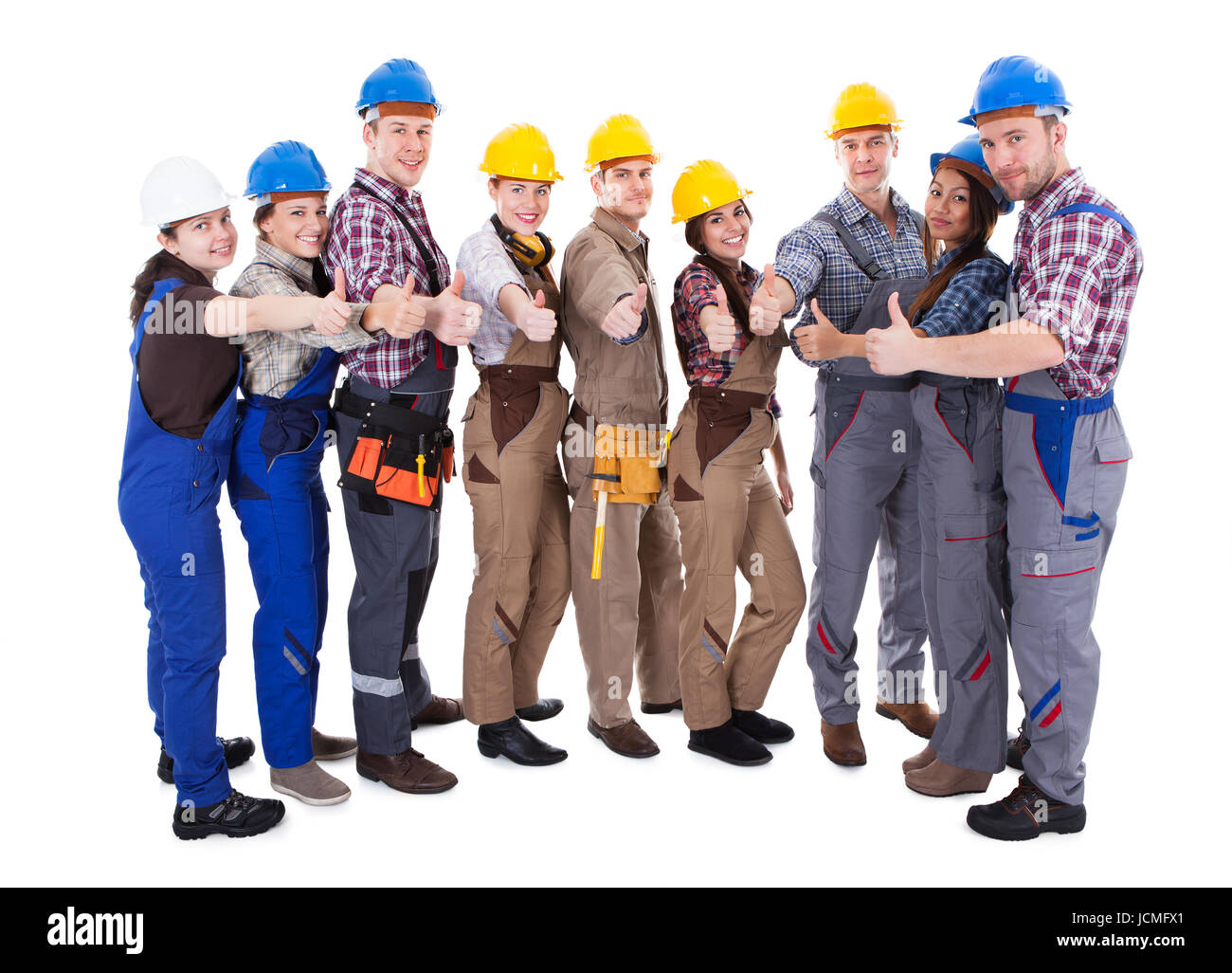 Diverse group of workmen and woman in their overalls and hardhats ...