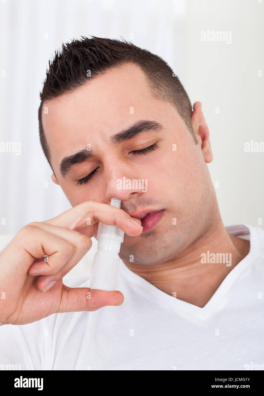 Young man nasal drops hi-res stock photography and images - Alamy