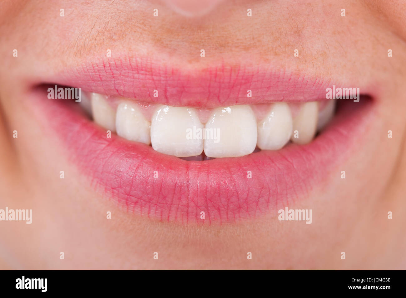 Cropped image of young woman with toothy smile Stock Photo - Alamy