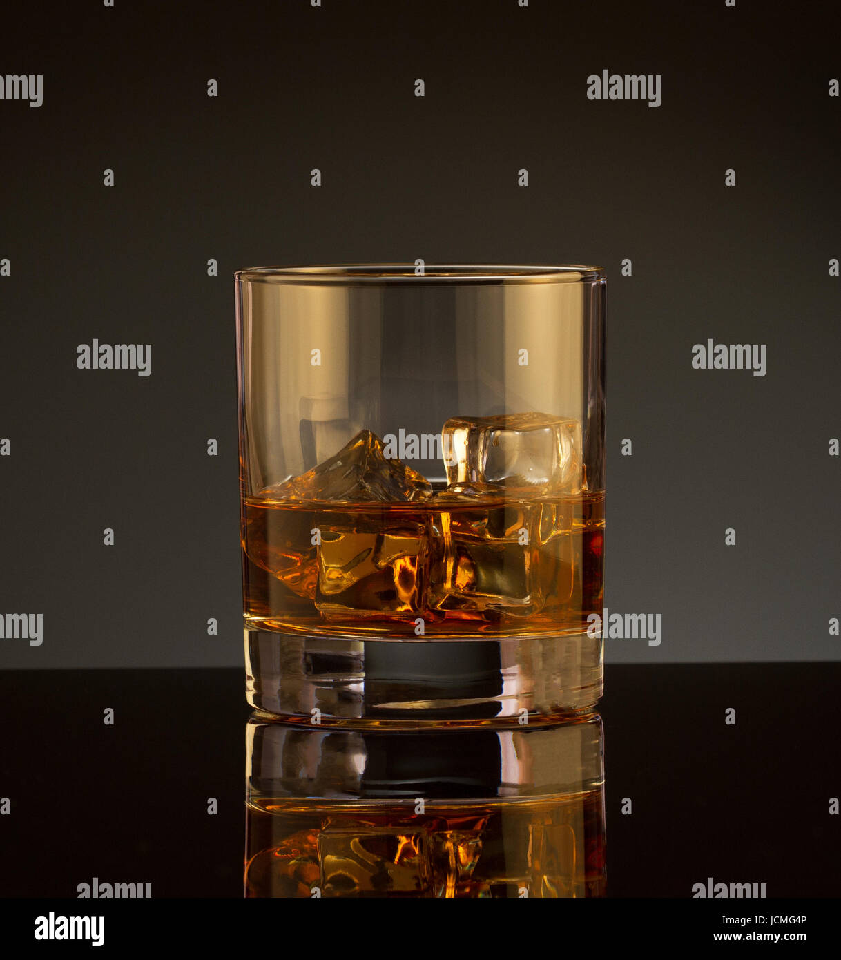 Glass of scotch whiskey and ice Stock Photo - Alamy