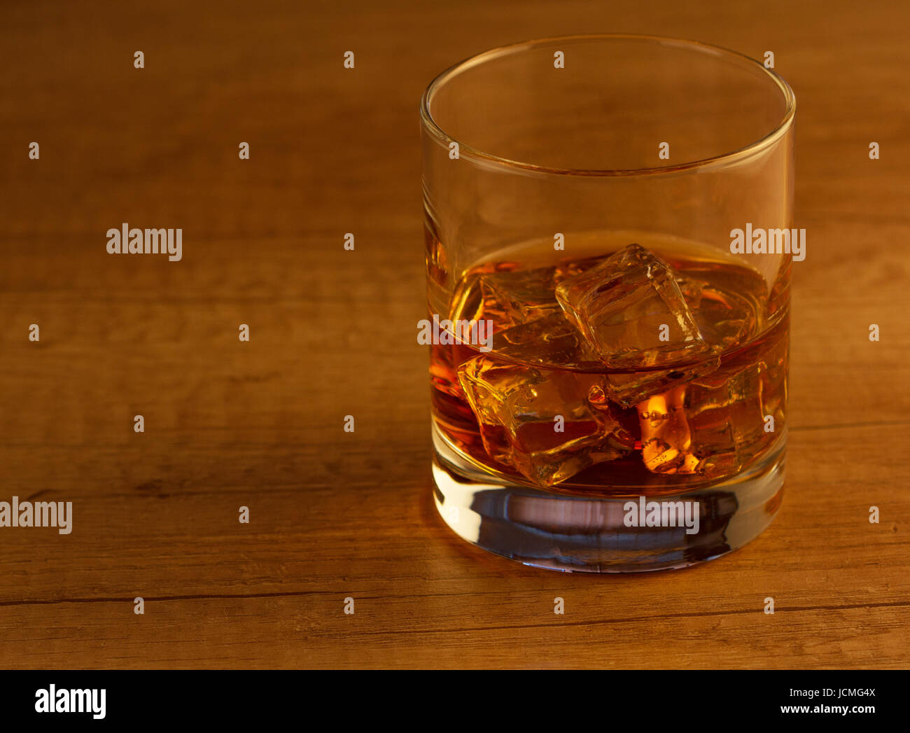 Glass of scotch whiskey and ice Stock Photo - Alamy