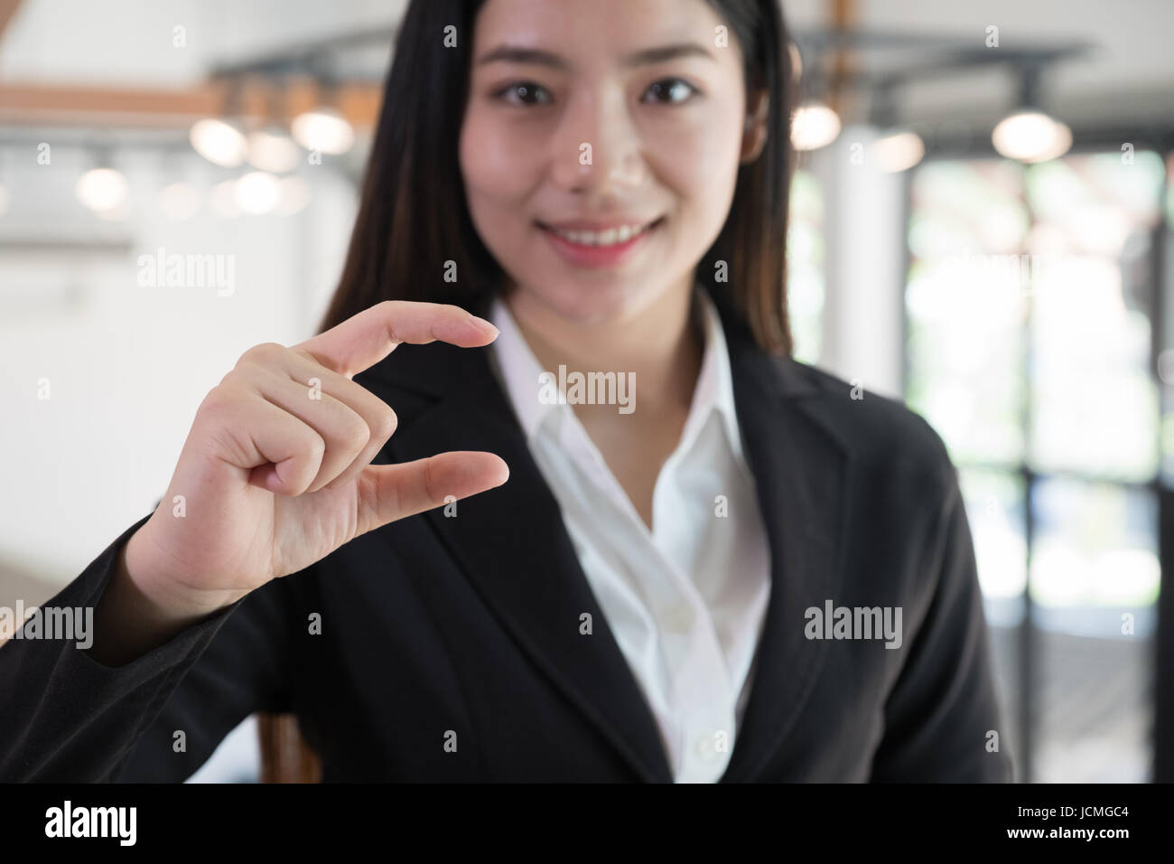 Businesswoman smiling and gesturing sizes with fingers. business ...