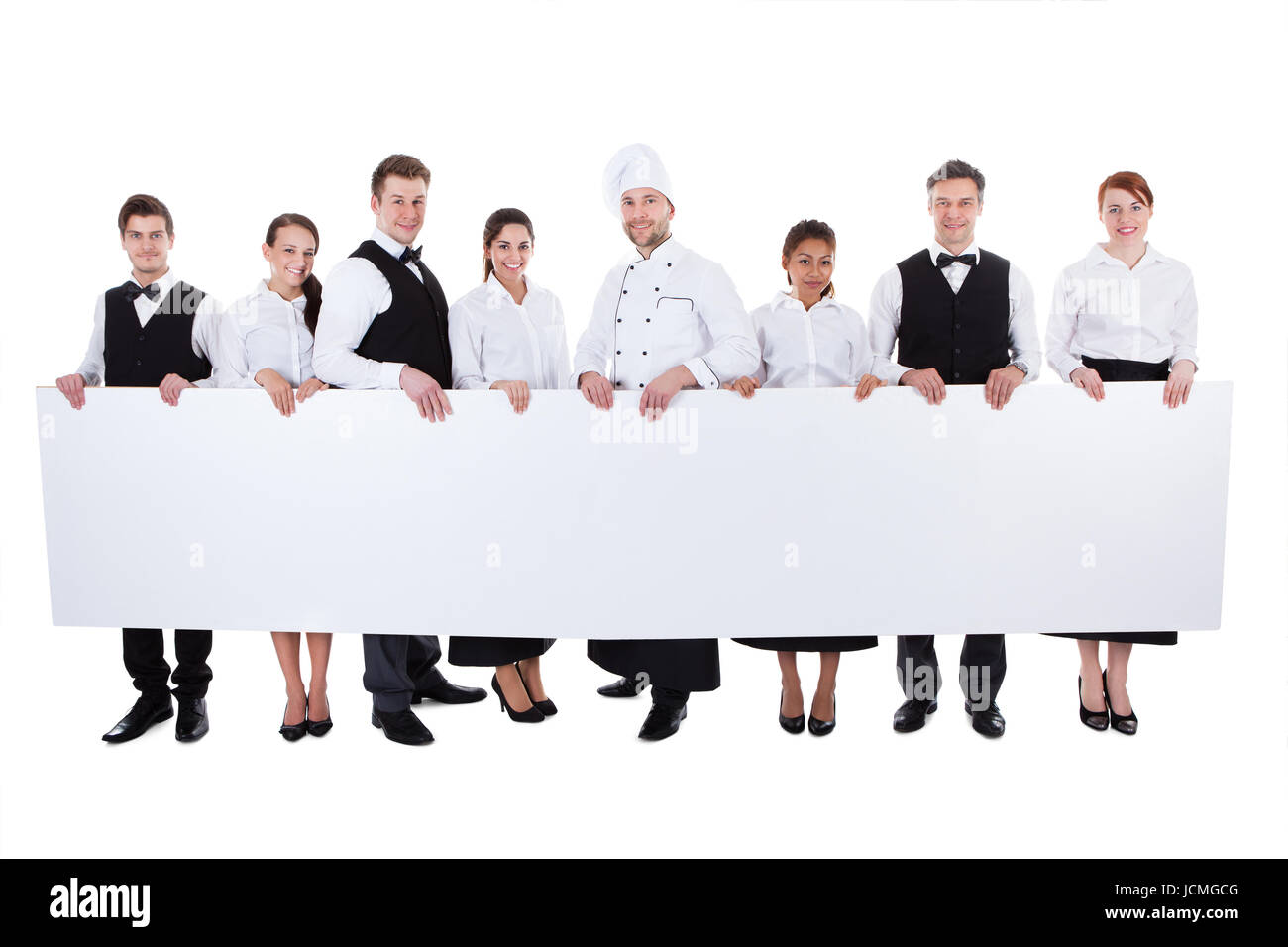Large group of catering staff holding a blank banner with copyspace for ...