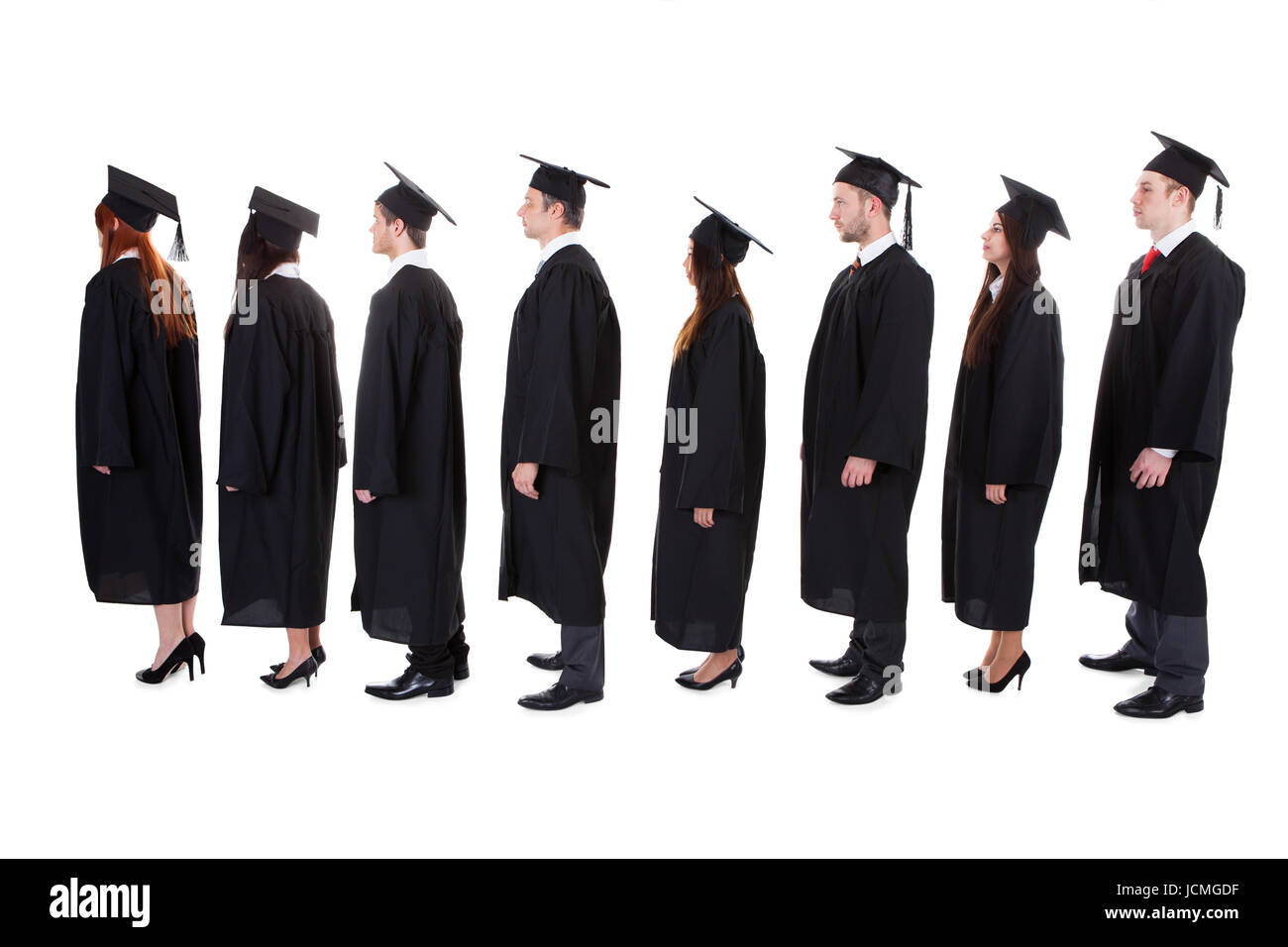 Graduate students standing in queue over white background Stock Photo ...