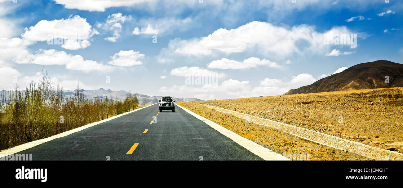 Long asphalt road in desert with blue and white sky Stock Photo - Alamy