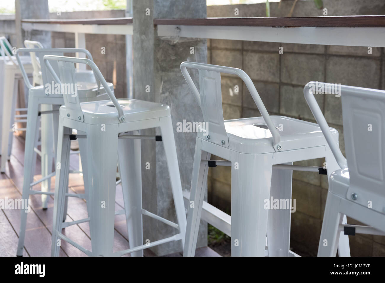 white shiny tall metal stool on terrace of cafe coffee shop or ...