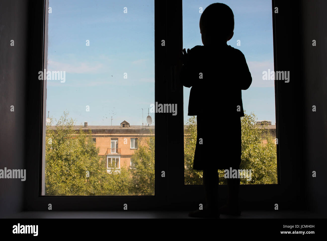 Child deviant behavior concept. The child looks out the window. Photo ...