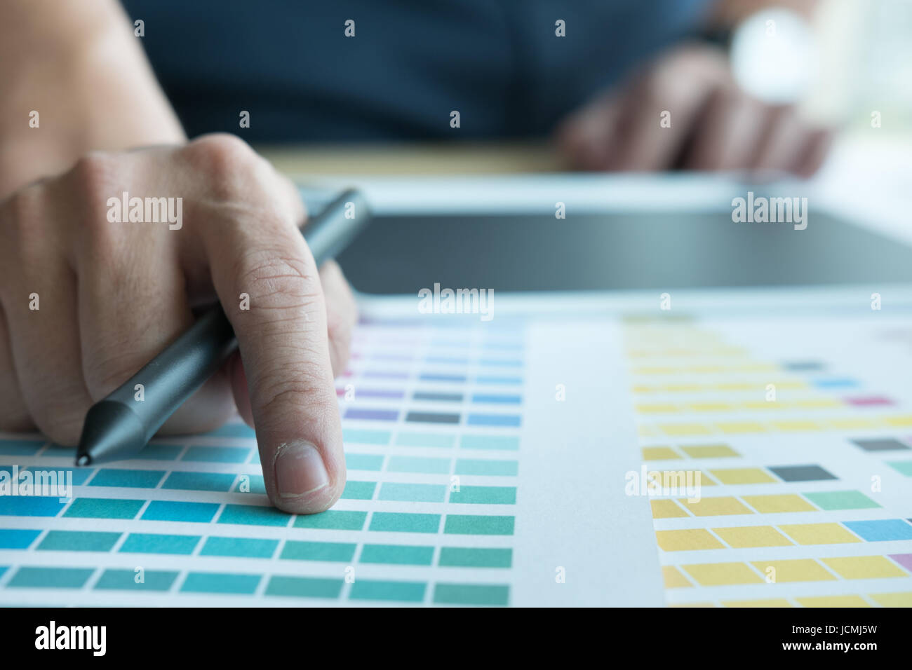 young male graphic designer working with color swatch. creative man ...