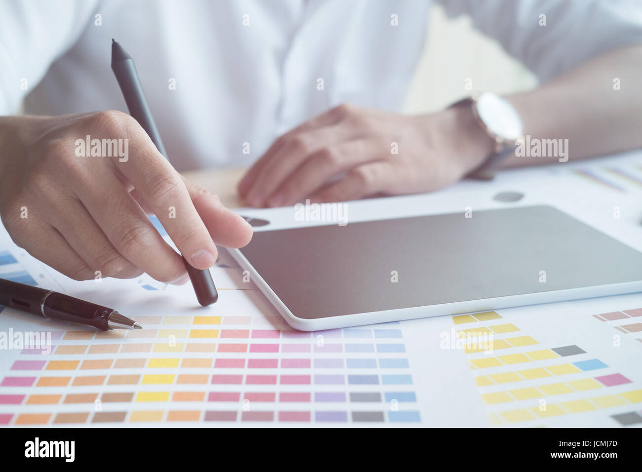 young male graphic designer working with color swatch. creative man ...