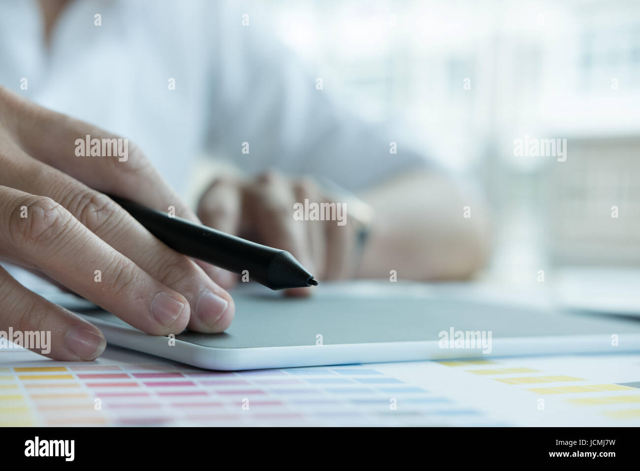 young male graphic designer working with color swatch. creative man ...