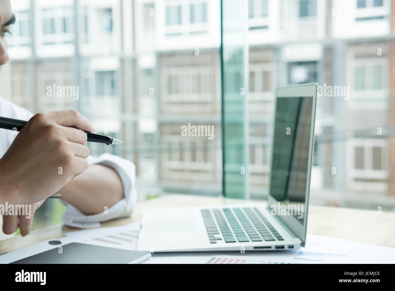 young male graphic designer working with computer, color swatch sample ...