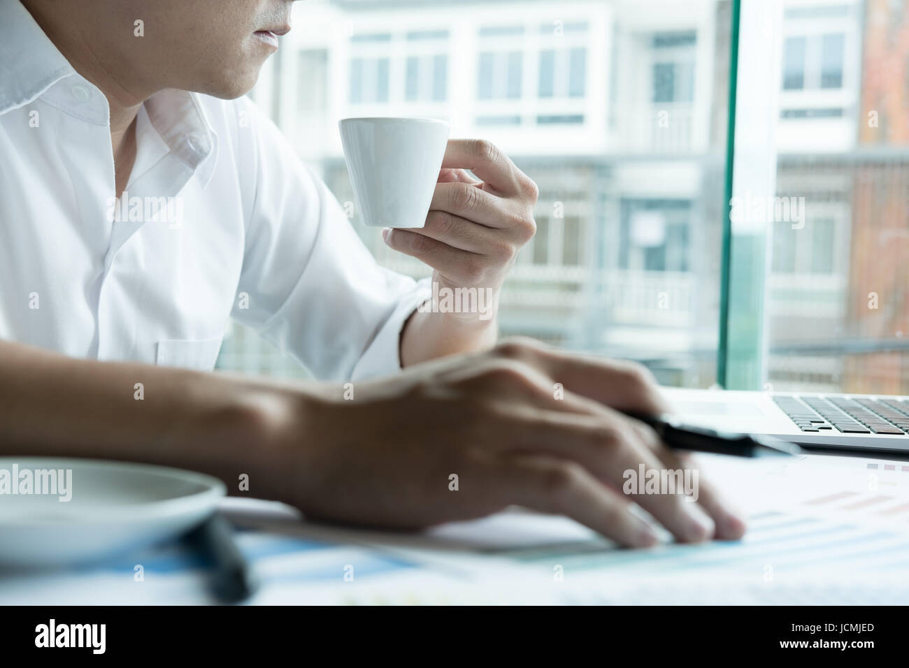 young male graphic designer working with computer at modern office ...