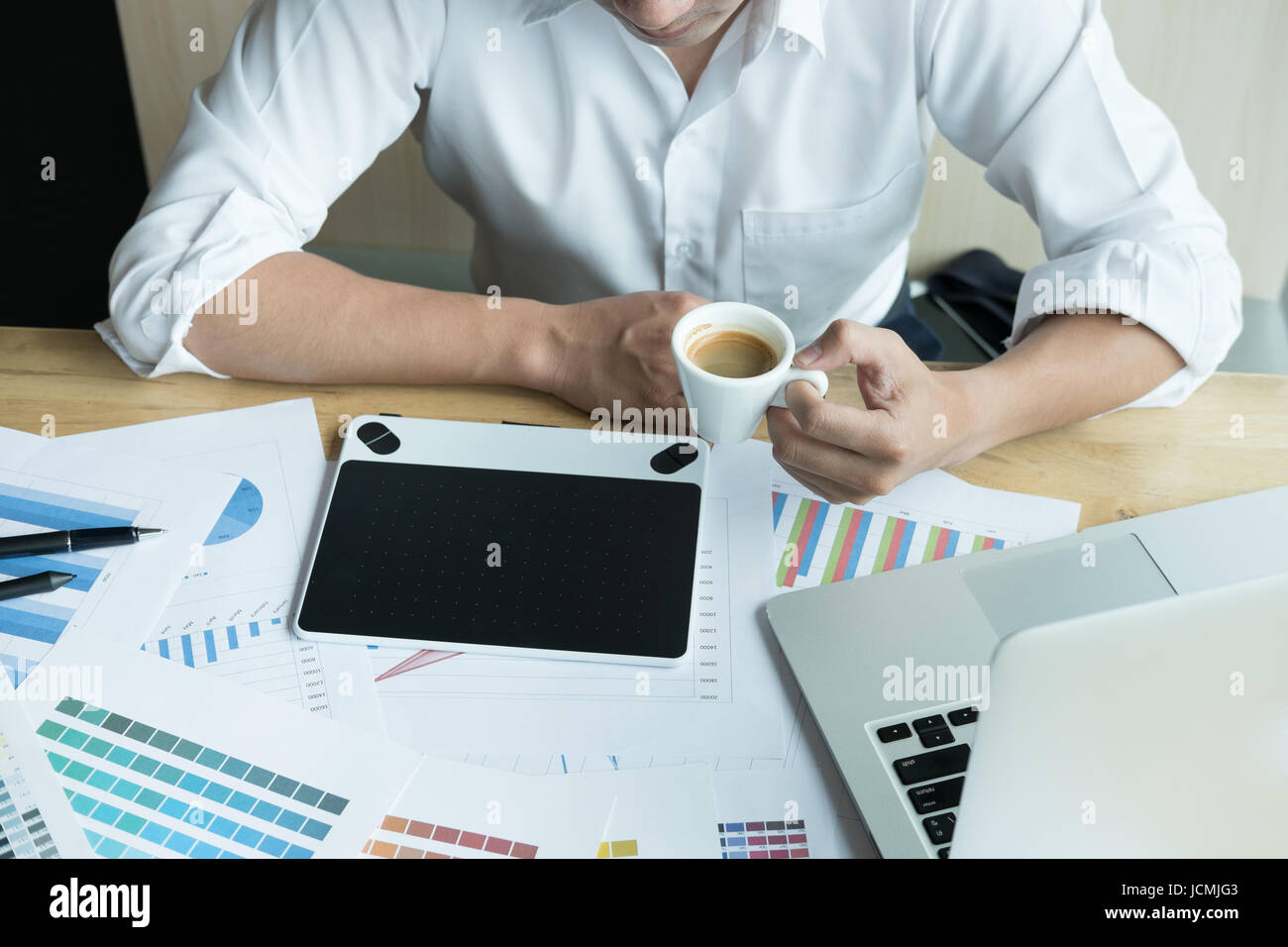 young male graphic designer working with computer. creative man using ...
