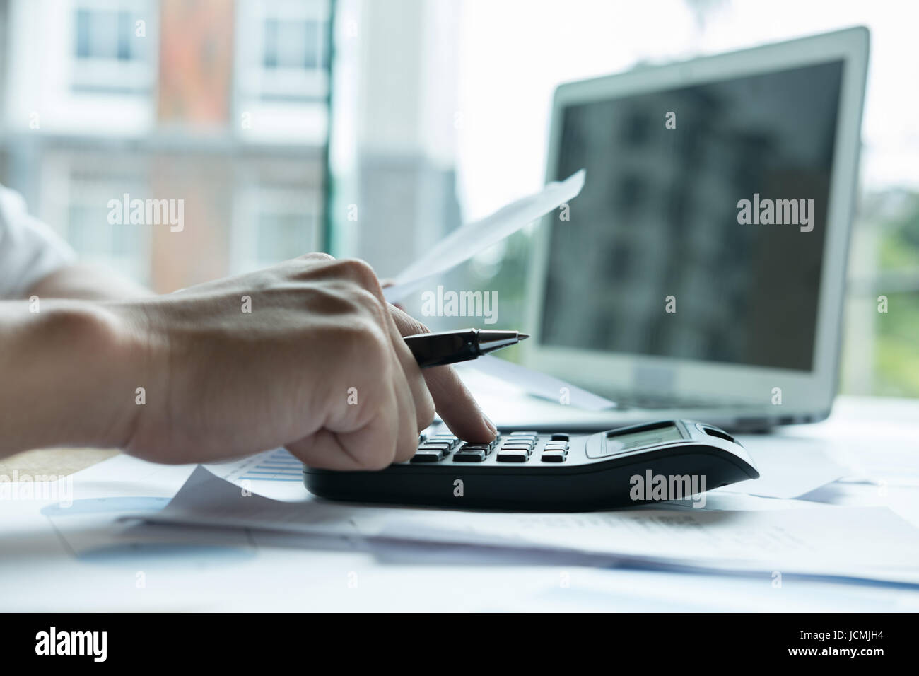 Man calculate domestic bills at home. Businessman using calculator at ...