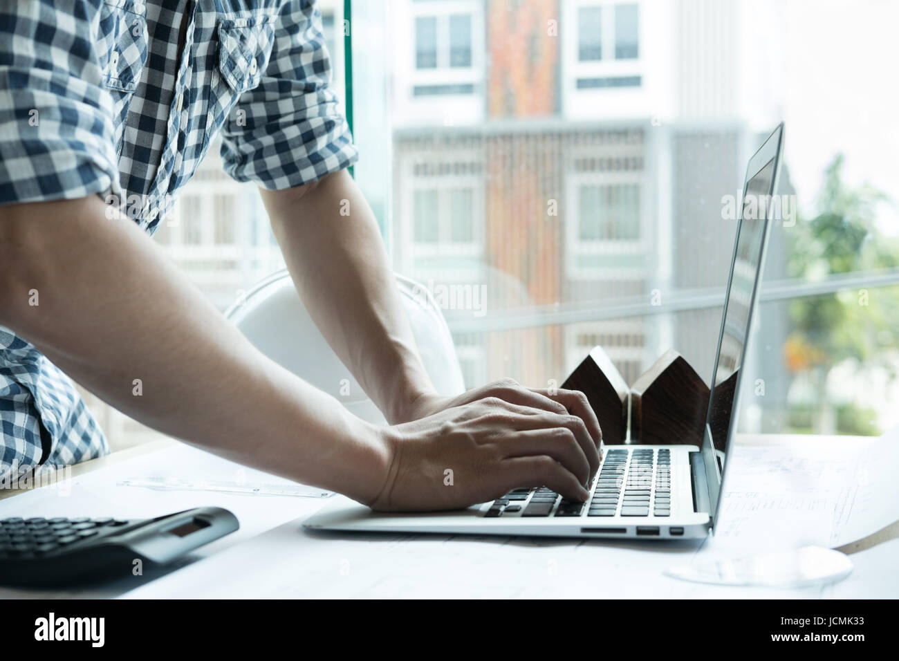 young architect working on real estate project at workplace. Male ...
