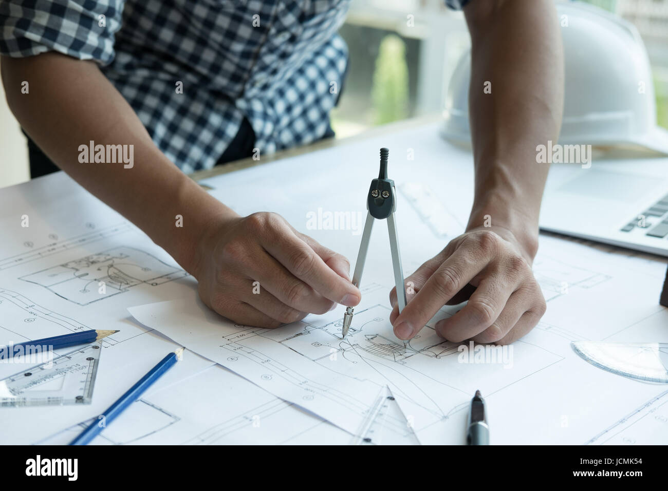 young architect working on real estate project at workplace. Engineer ...