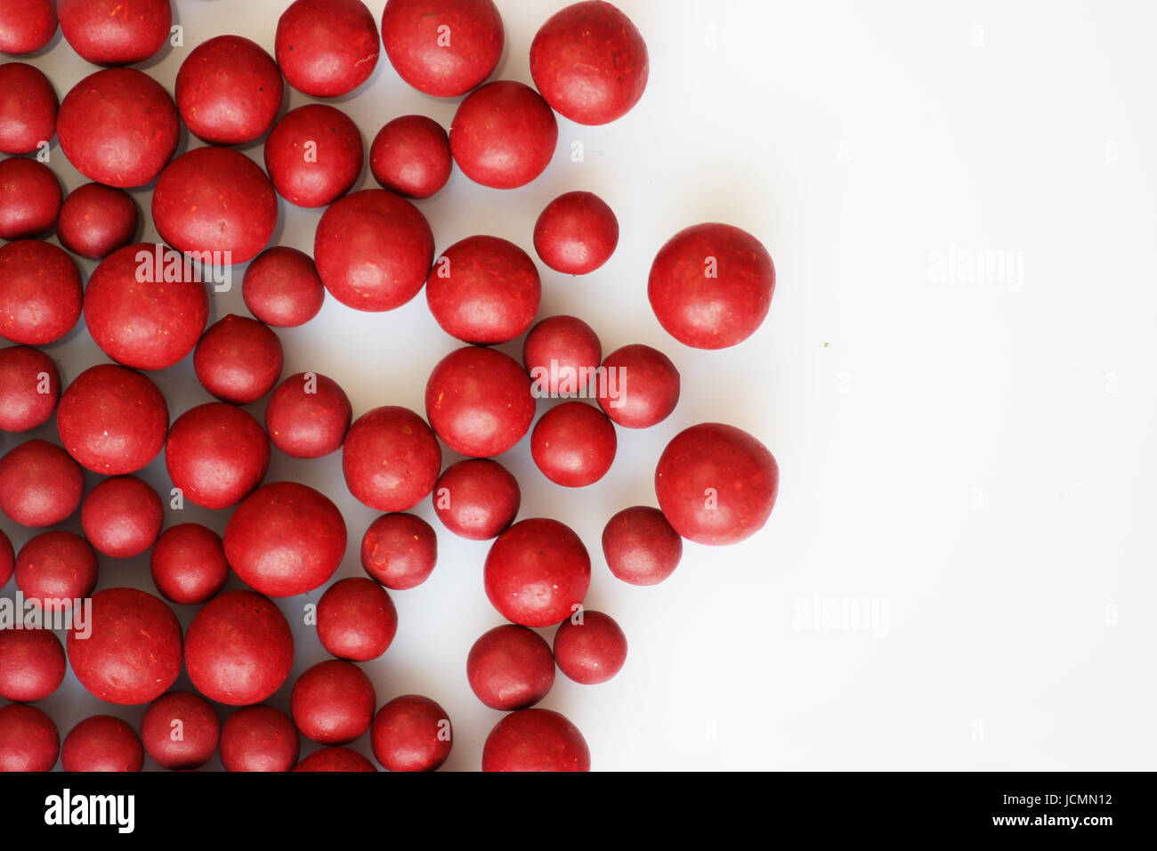 Macro photo of many red ball-shaped pills. Tibetan folk medicine from ...