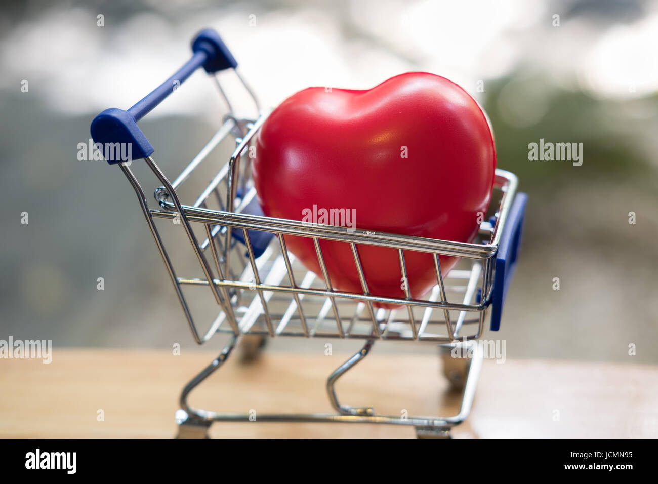 Big red heart in a blue shopping cart. Valentine's Day, buying love ...