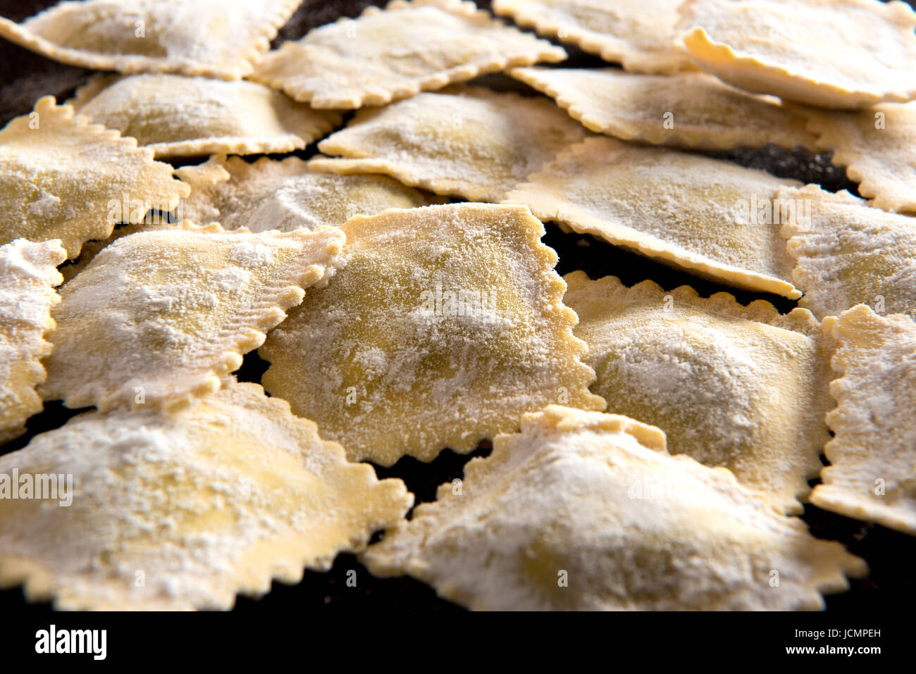Close-up of rectangular shape raw handmade Italian ravioli pasta with ...