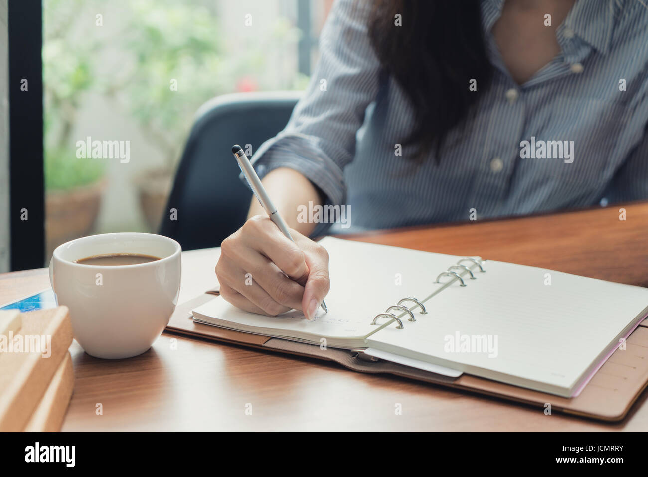 Woman sitting in chair writing hi-res stock photography and images - Alamy