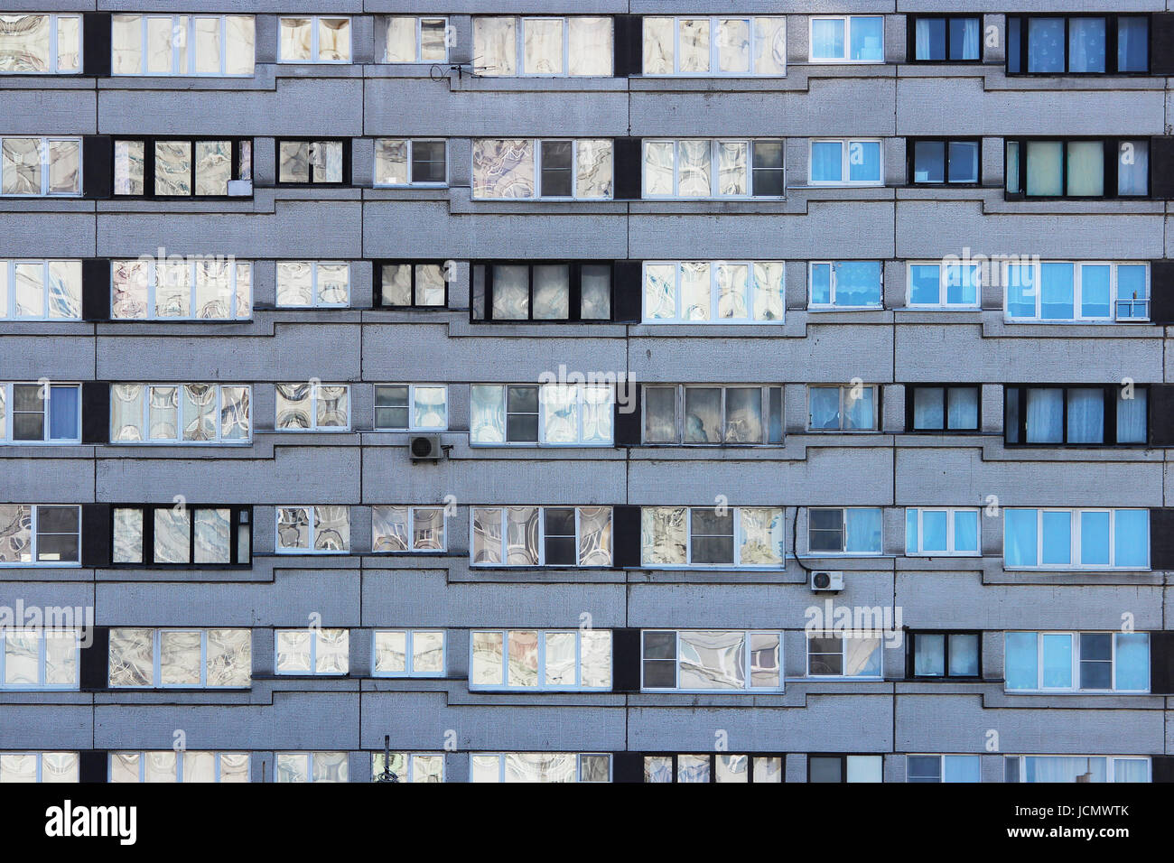 texture of an apartment building with many windows in the afternoon ...