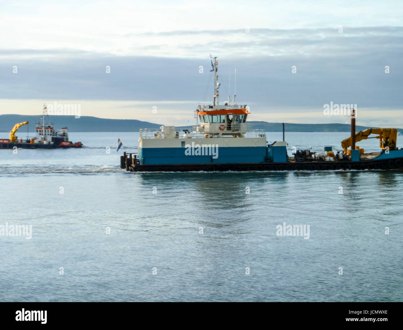 A small service ship in a cargo industrial port. A ship in the sea ...