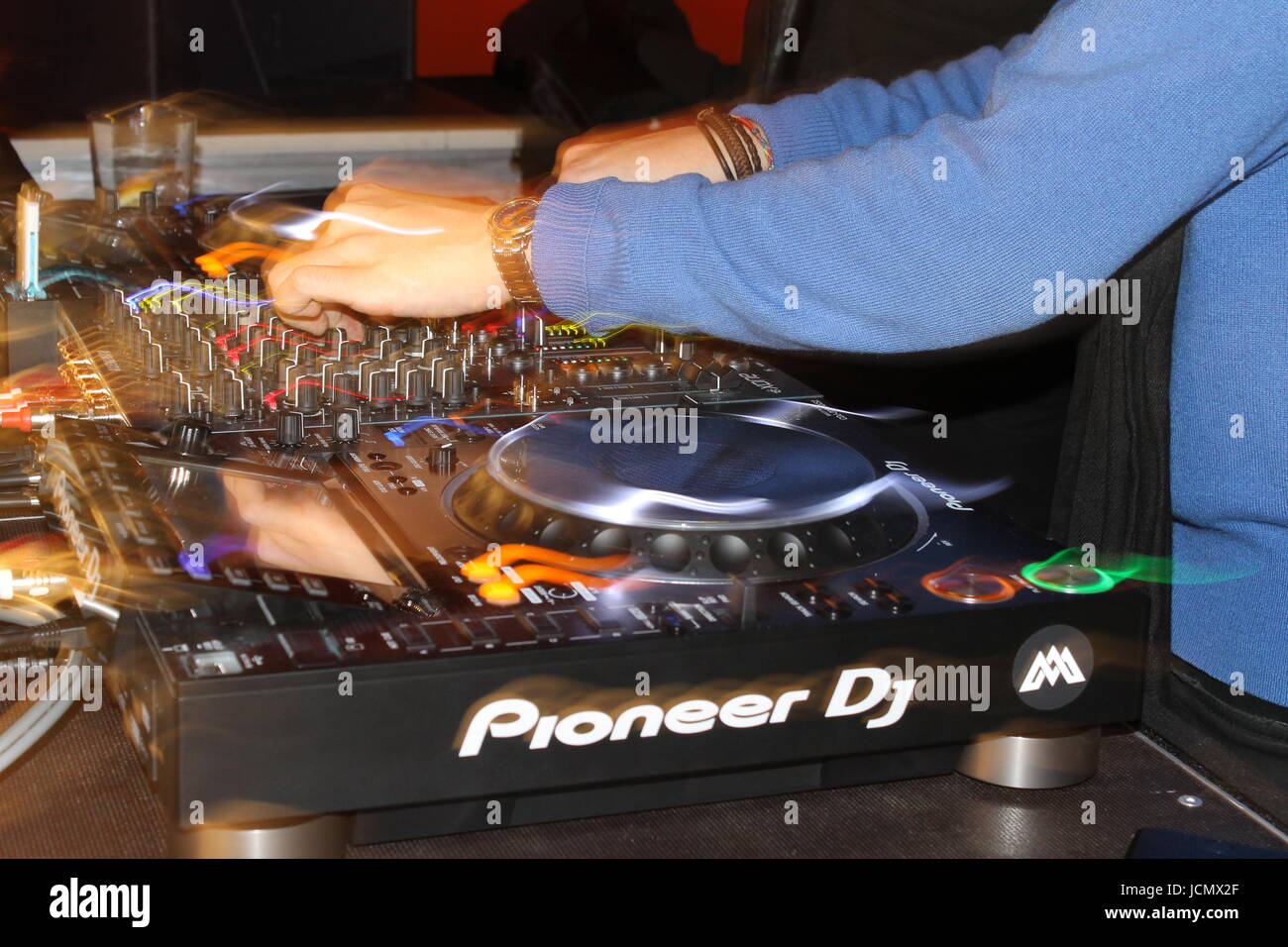 Close up of a DJ playing with CDJs and a mixer Stock Photo - Alamy
