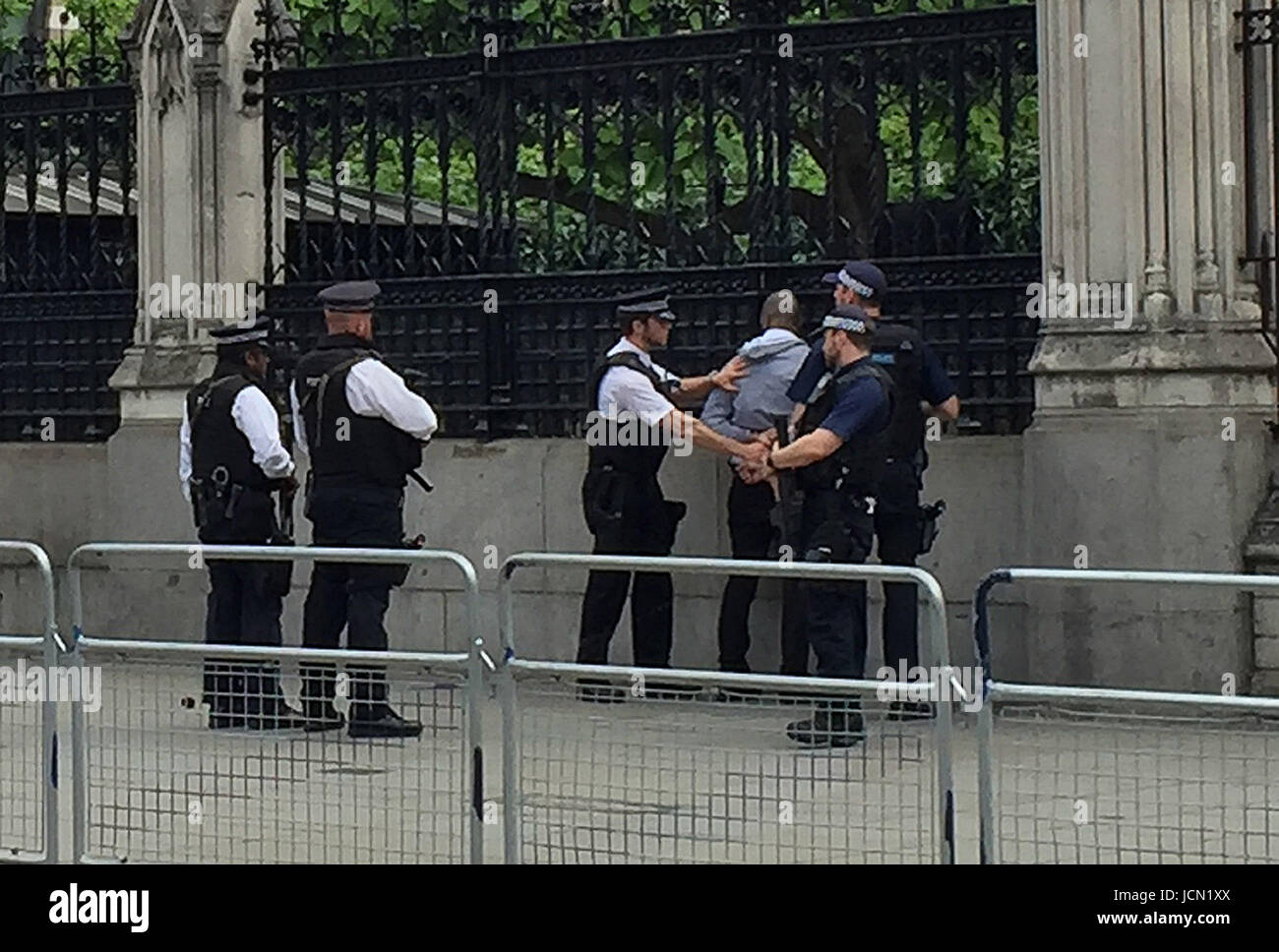 Police detain a man outside the Palace of Westminster, London Stock ...
