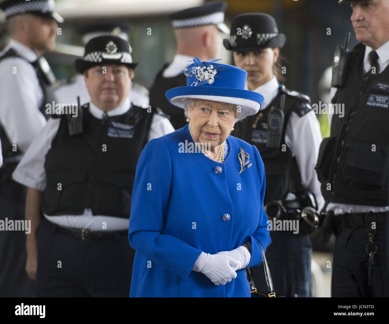 Queen Elizabeth II speaks to emergency services personnel as she ...
