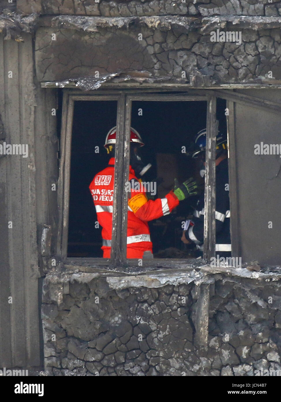 Fire service personnel survey the damage inside Grenfell Tower in west ...