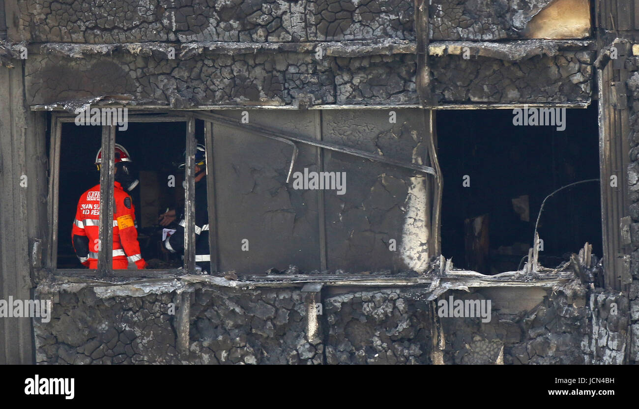 Fire service personnel survey the damage inside Grenfell Tower in west ...