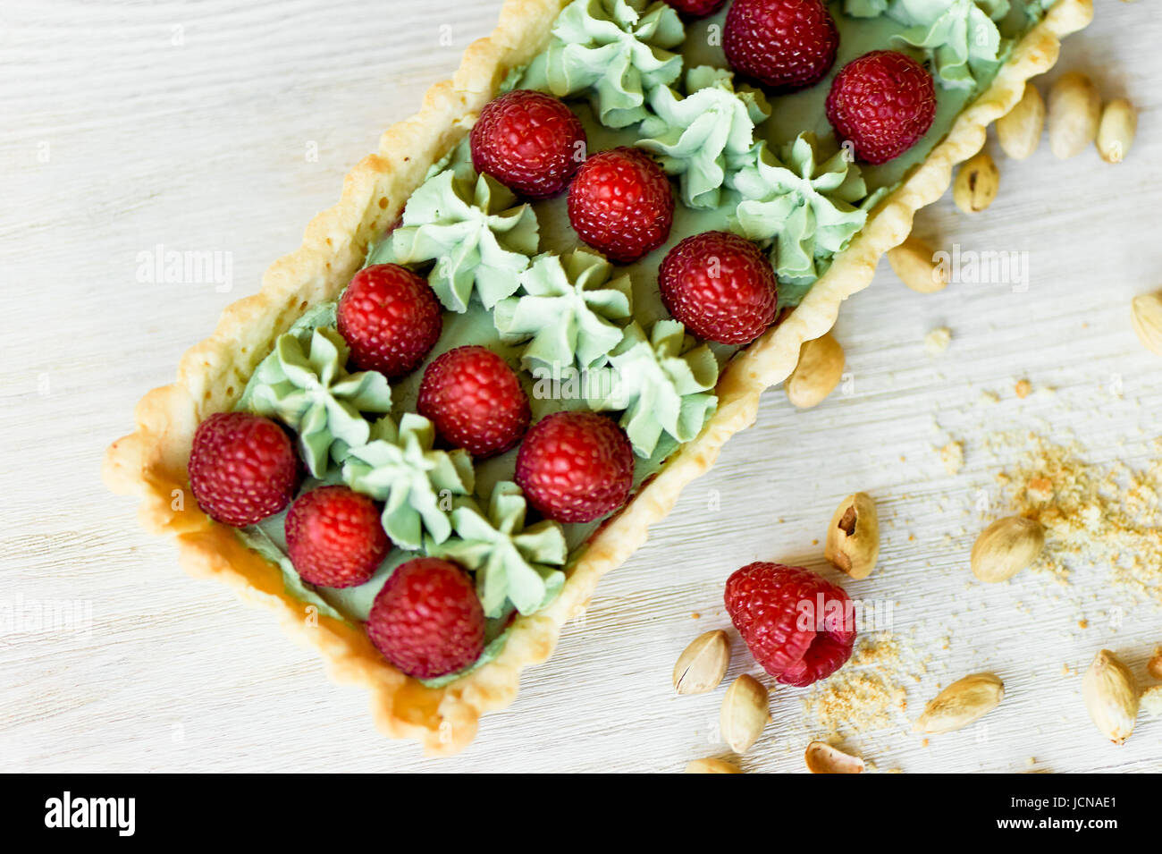 Pistachio tart. Pistachio tart on white Belgian chocolate BARRY with a ...