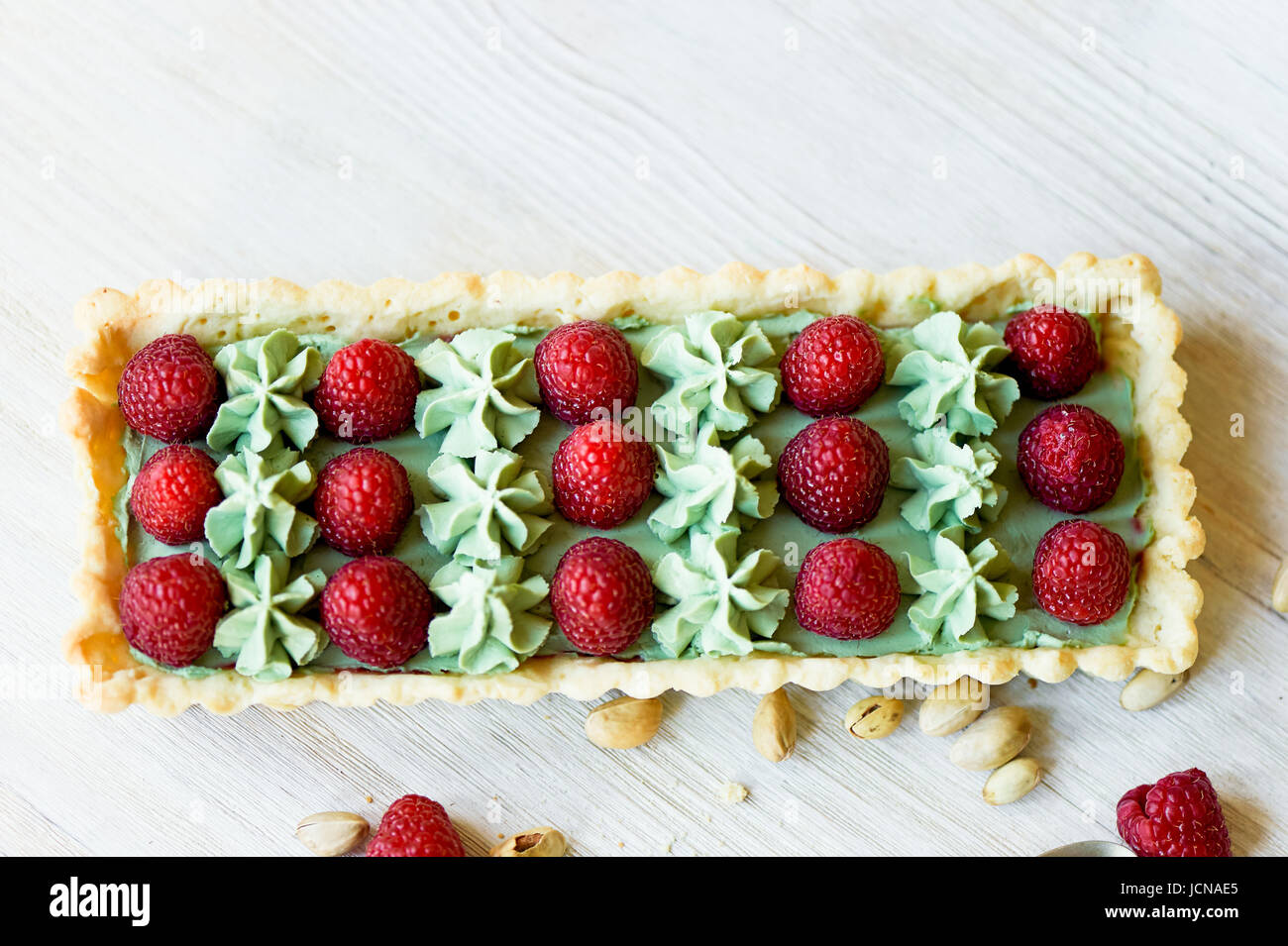 Pistachio tart. Pistachio tart on white Belgian chocolate BARRY with a ...