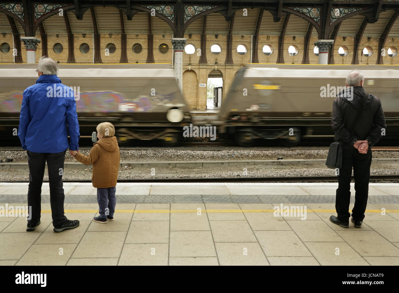 People at York station watching coal train passing Stock Photo - Alamy