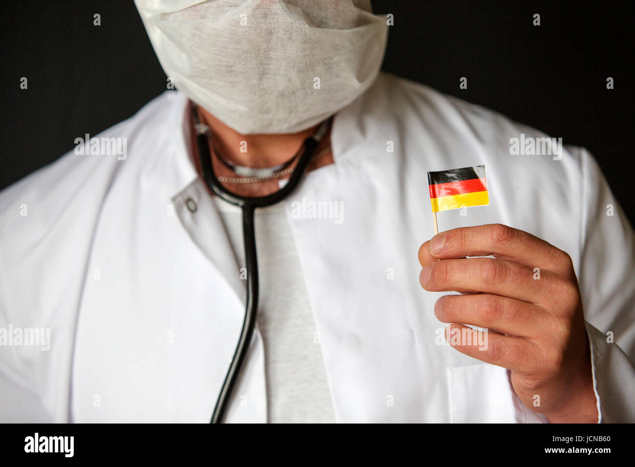 doctor with mouthguard holding a small german flag Stock Photo - Alamy