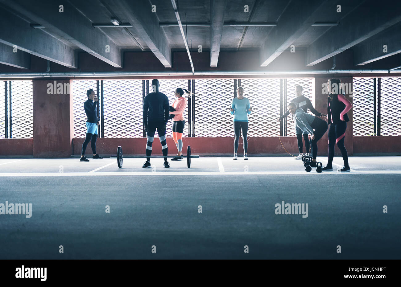 View of several sportsmen doing various exercises over huge windows in ...