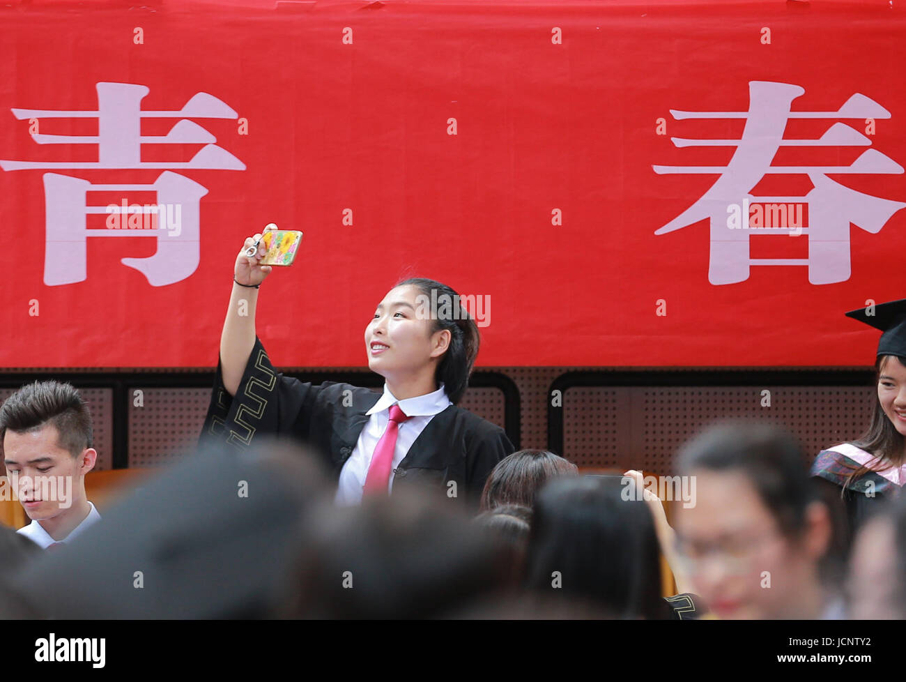 Tianjin. 16th June, 2017. A student takes pictures at a graduation ...