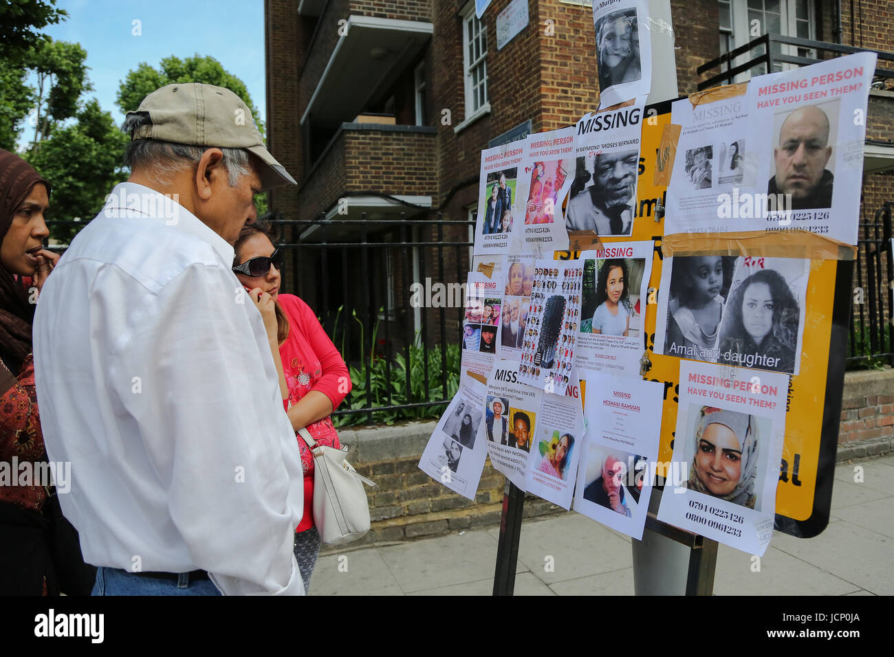 London, UK. 16th June, 2017. People look at the missing persons posters ...